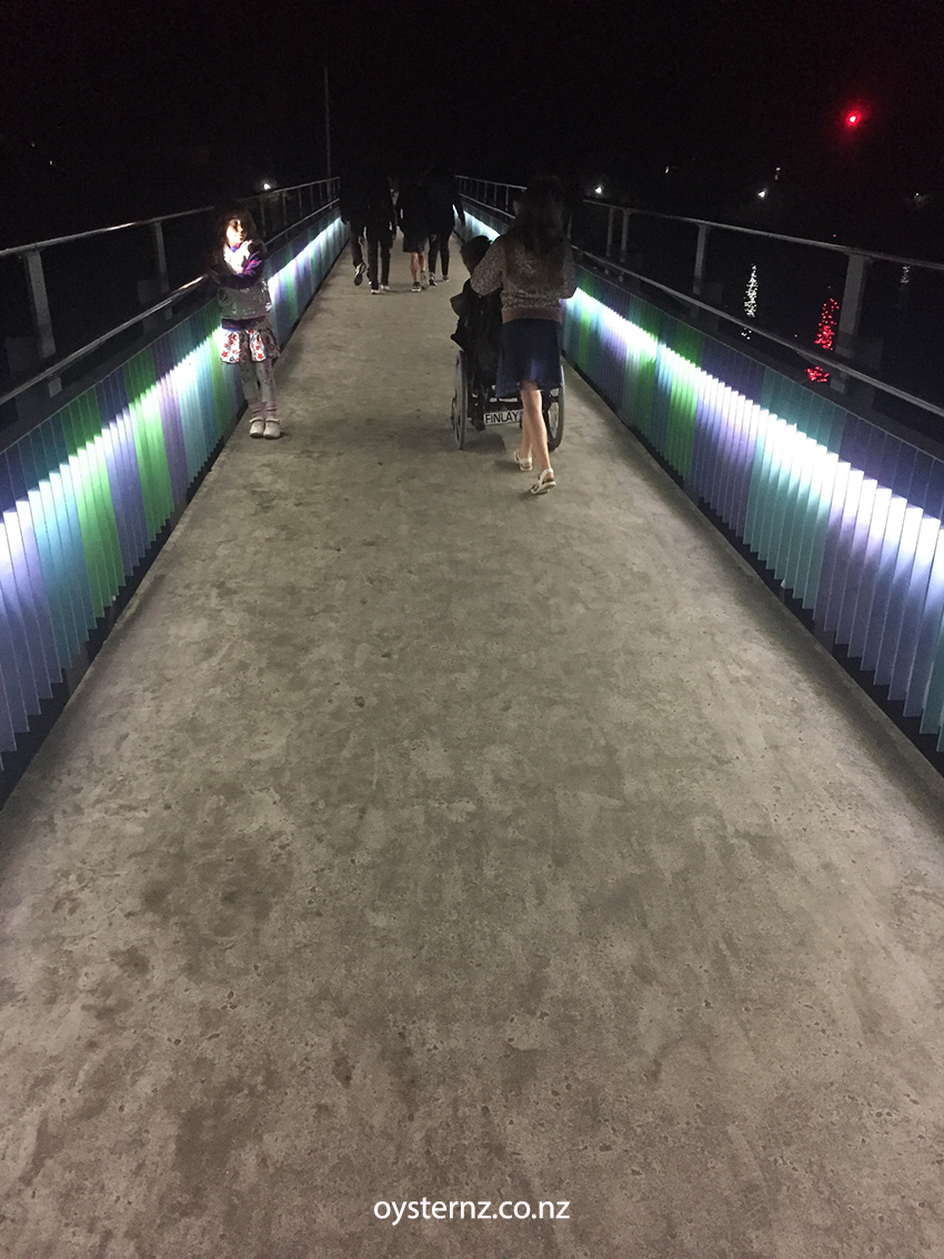 Bridge lit up at night walking along – Grab your wheels, Let's travel